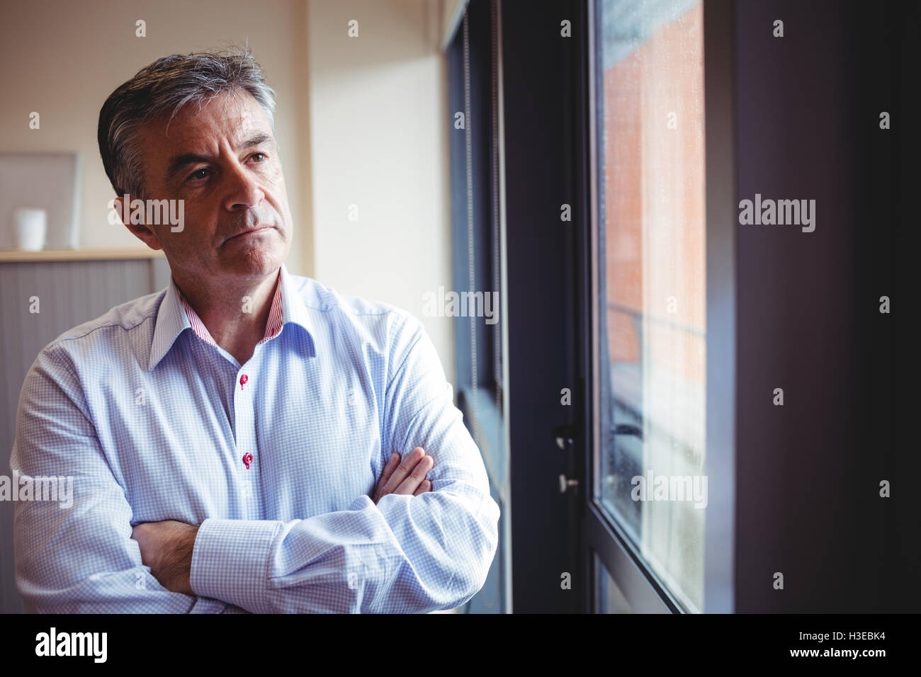 Doctor standing near window Stock Photo - Alamy
