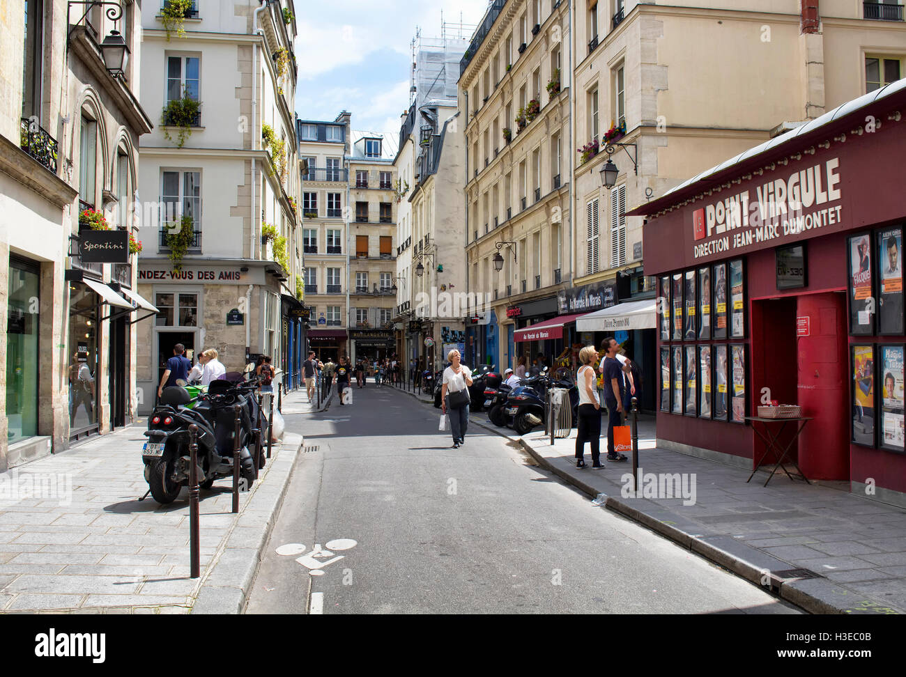People walk on one of streets of Le Marais district of Paris. This area ...