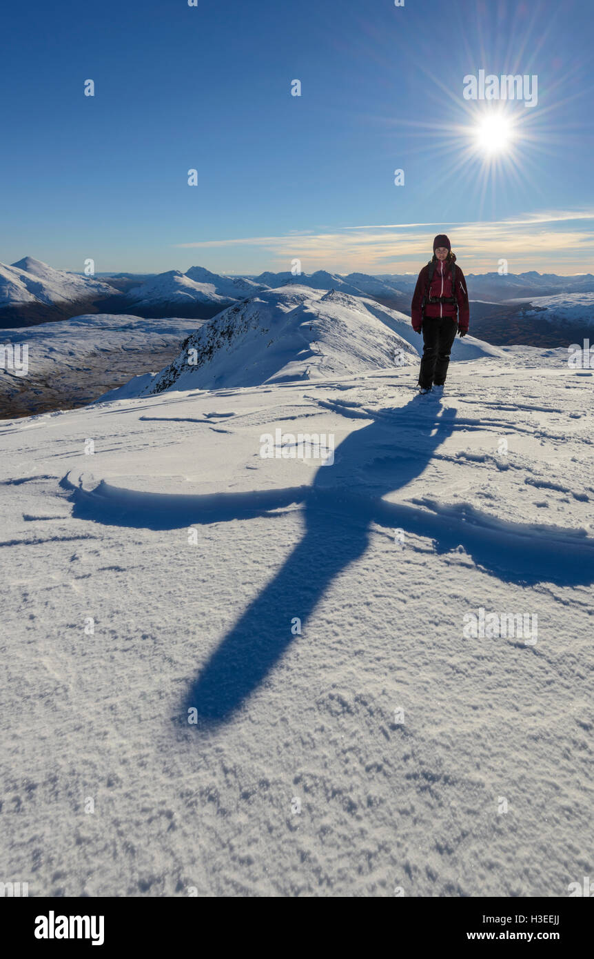 Female hill walker ascending the Munro Ben Challum in winter conditions ...