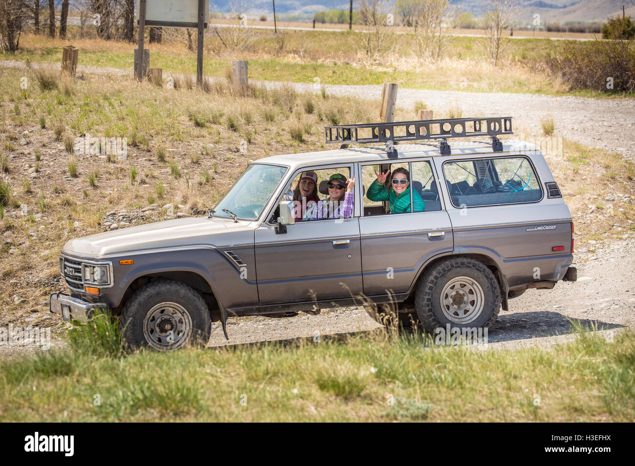 Three women drive through Montana in a 1900 Land Cruiser Stock Photo ...