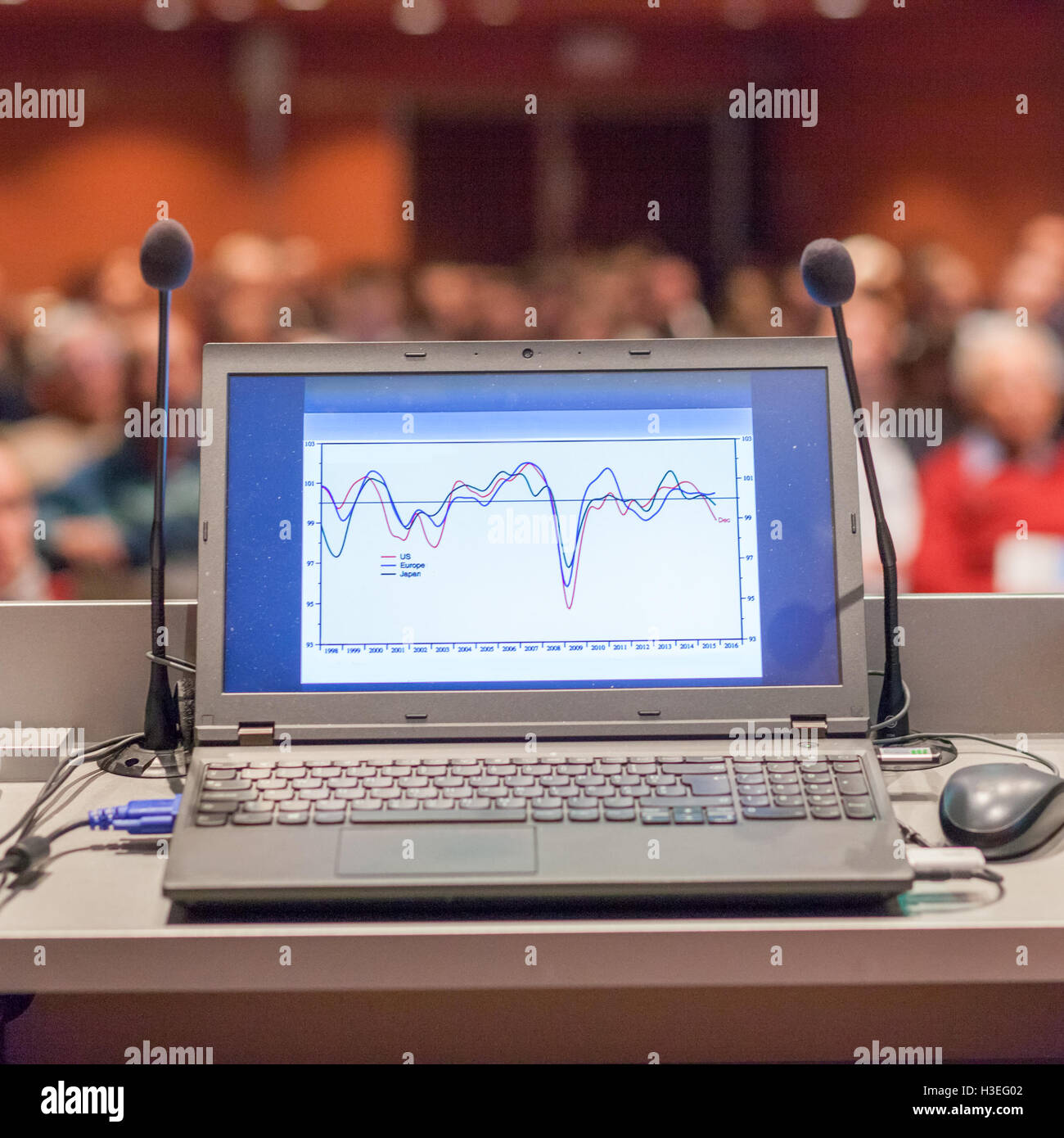 Computer and microphone on rostrum at business event Stock Photo - Alamy