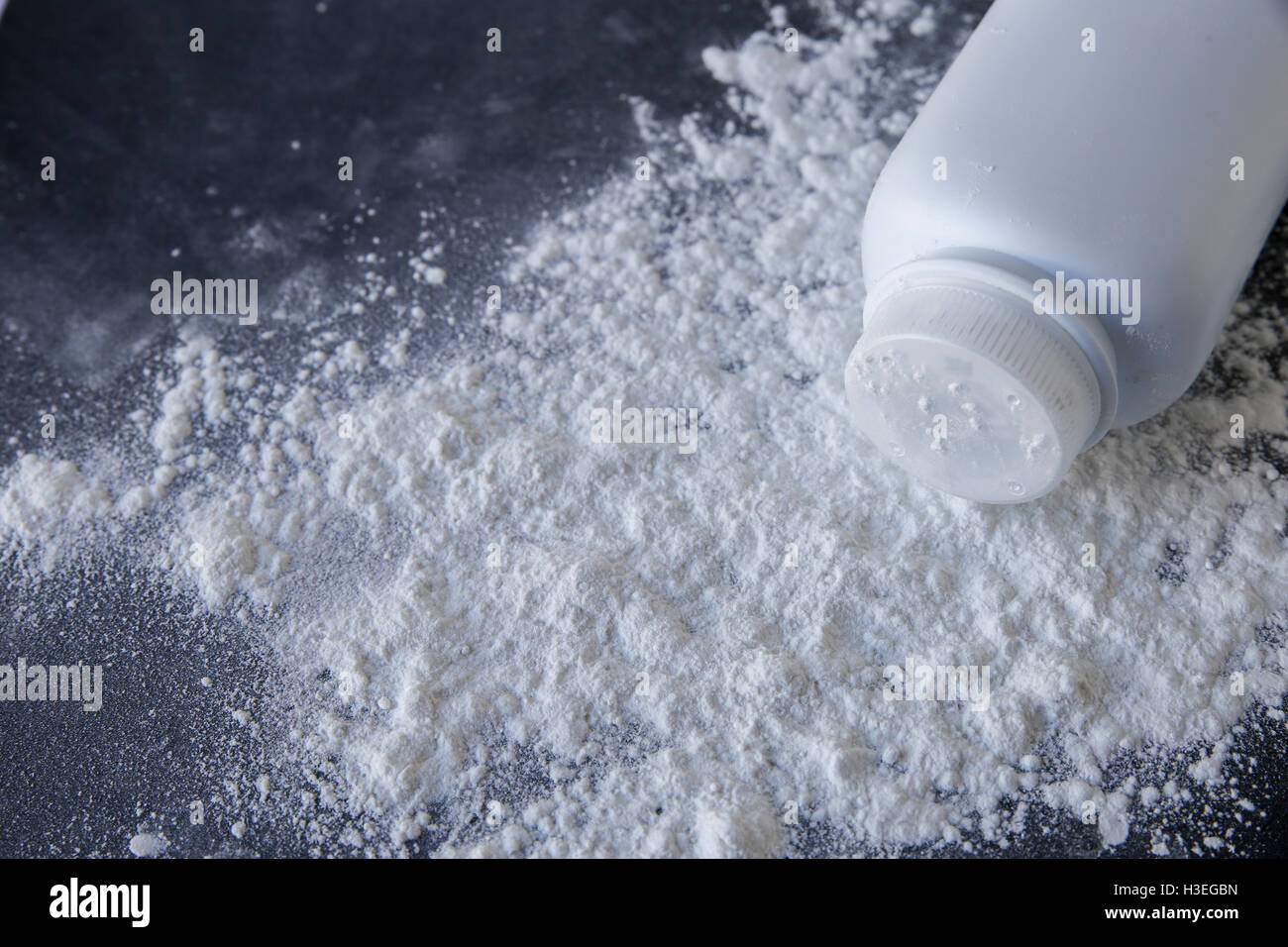 Talcum powder on black background Stock Photo - Alamy