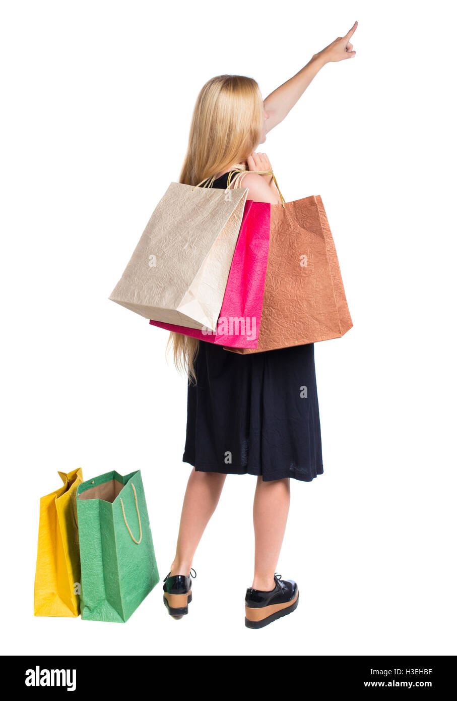 back view of woman with shopping bags pointing . beautiful blonde girl ...