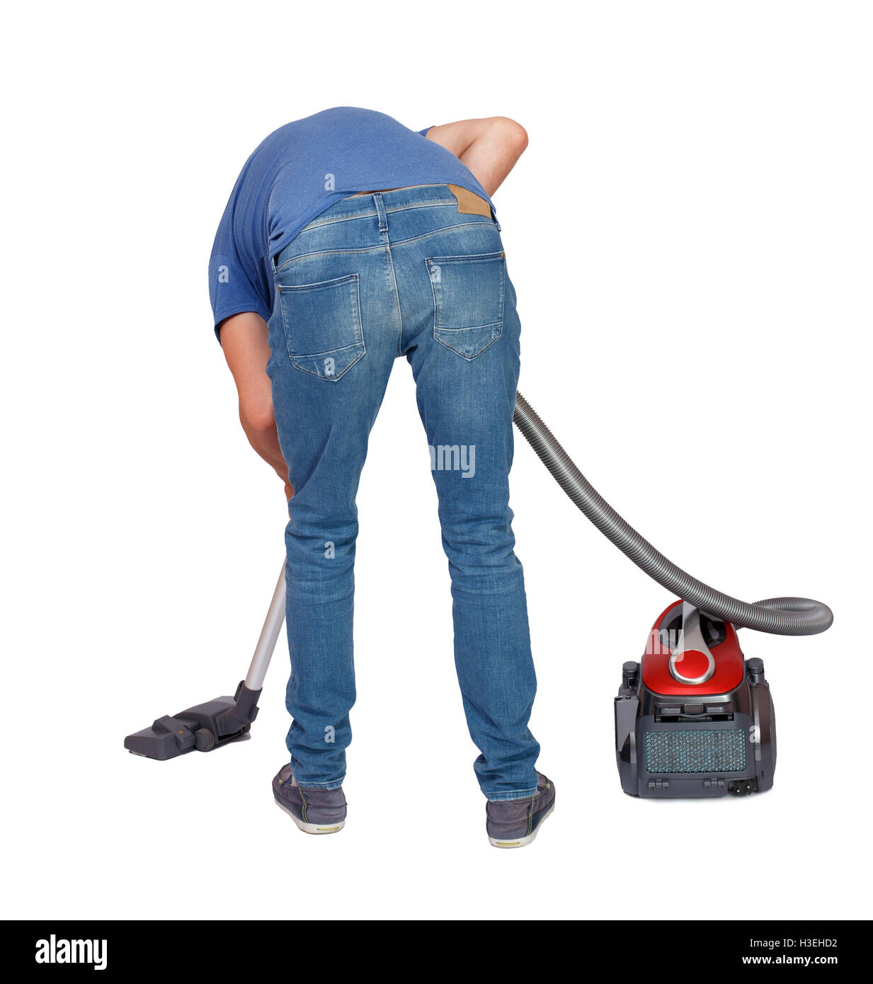 Rear view of a man with a vacuum cleaner. He is busy cleaning. Rear ...