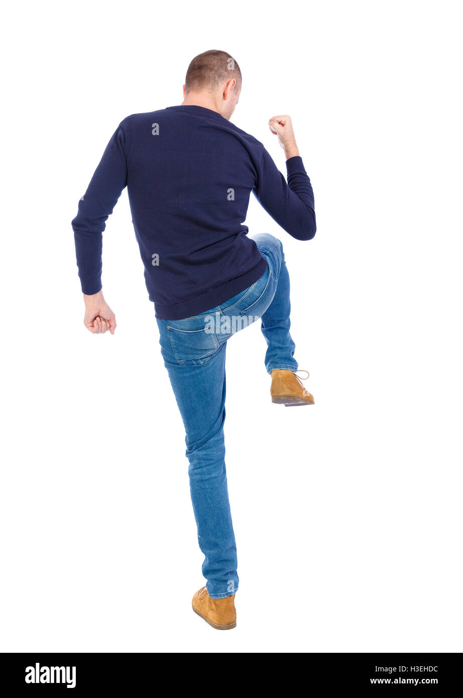 Back view of man. Raised his fist up in victory sign. Rear view people ...