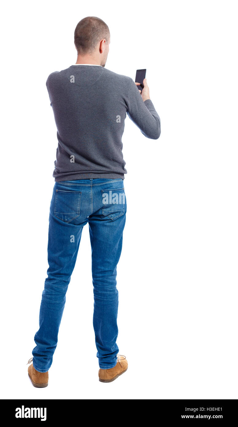 Back view of pointing young men talking on cell phone. Young guy ...