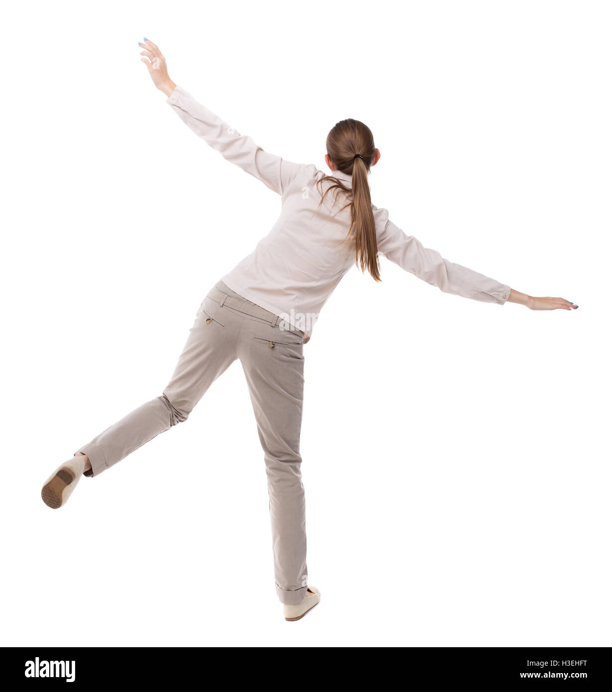 Balancing young woman. or dodge falling woman. Rear view people ...