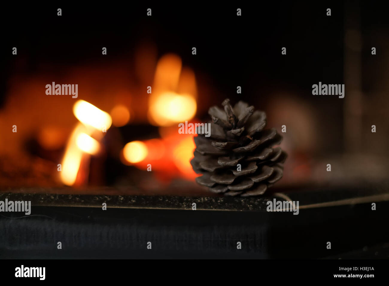 Fir cone at the fire place Stock Photo - Alamy