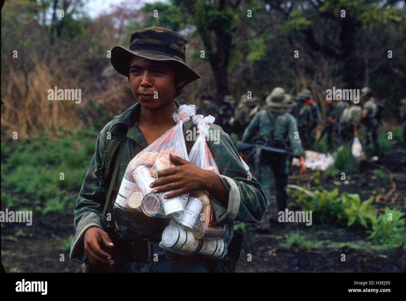 El Salvador, 1986. Government soldiers arrive by helicopter with ...