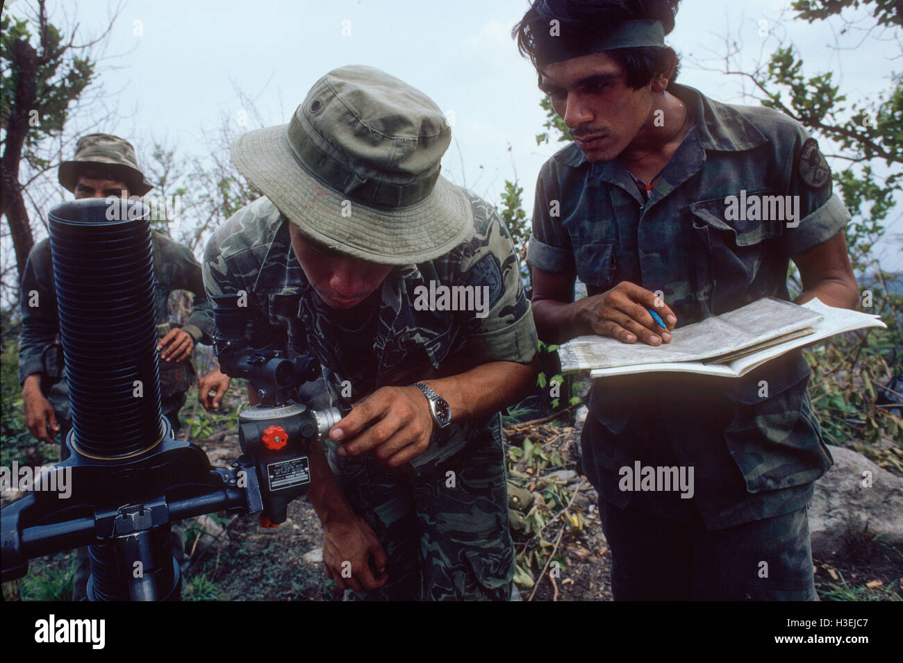 El Salvador, 1986. Government soldiers e on patrol in Morazan Province prepare to fire mortar ...