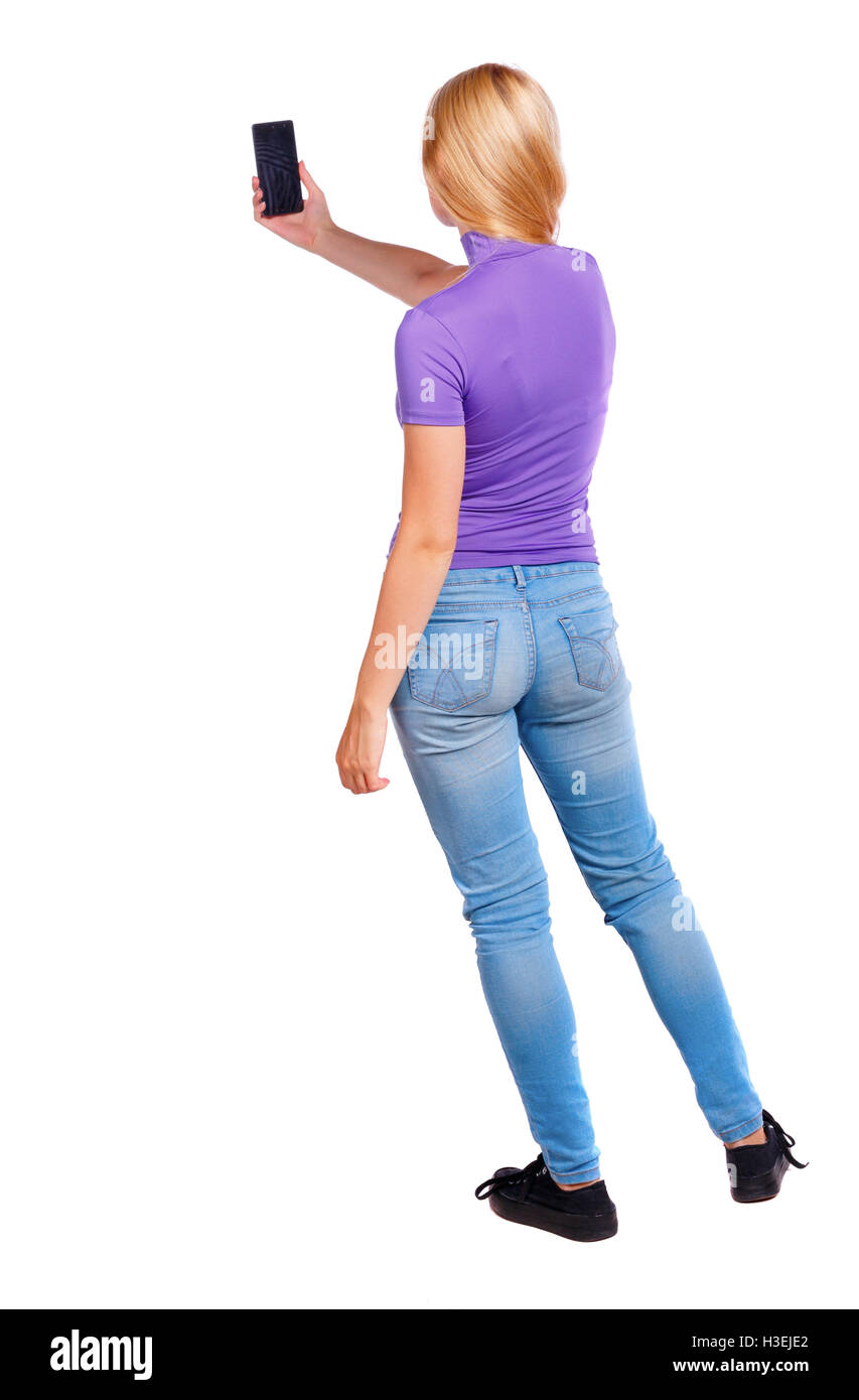 back view of standing young beautiful girl with tablet computer in the ...