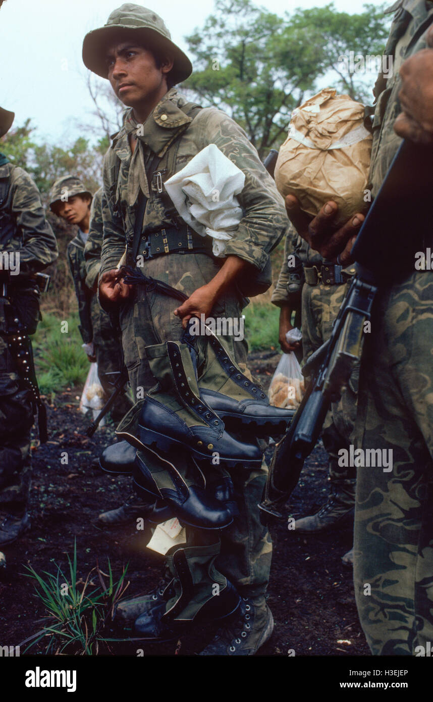 El Salvador, 1986. Government soldiers arrive by helicoptert with ...
