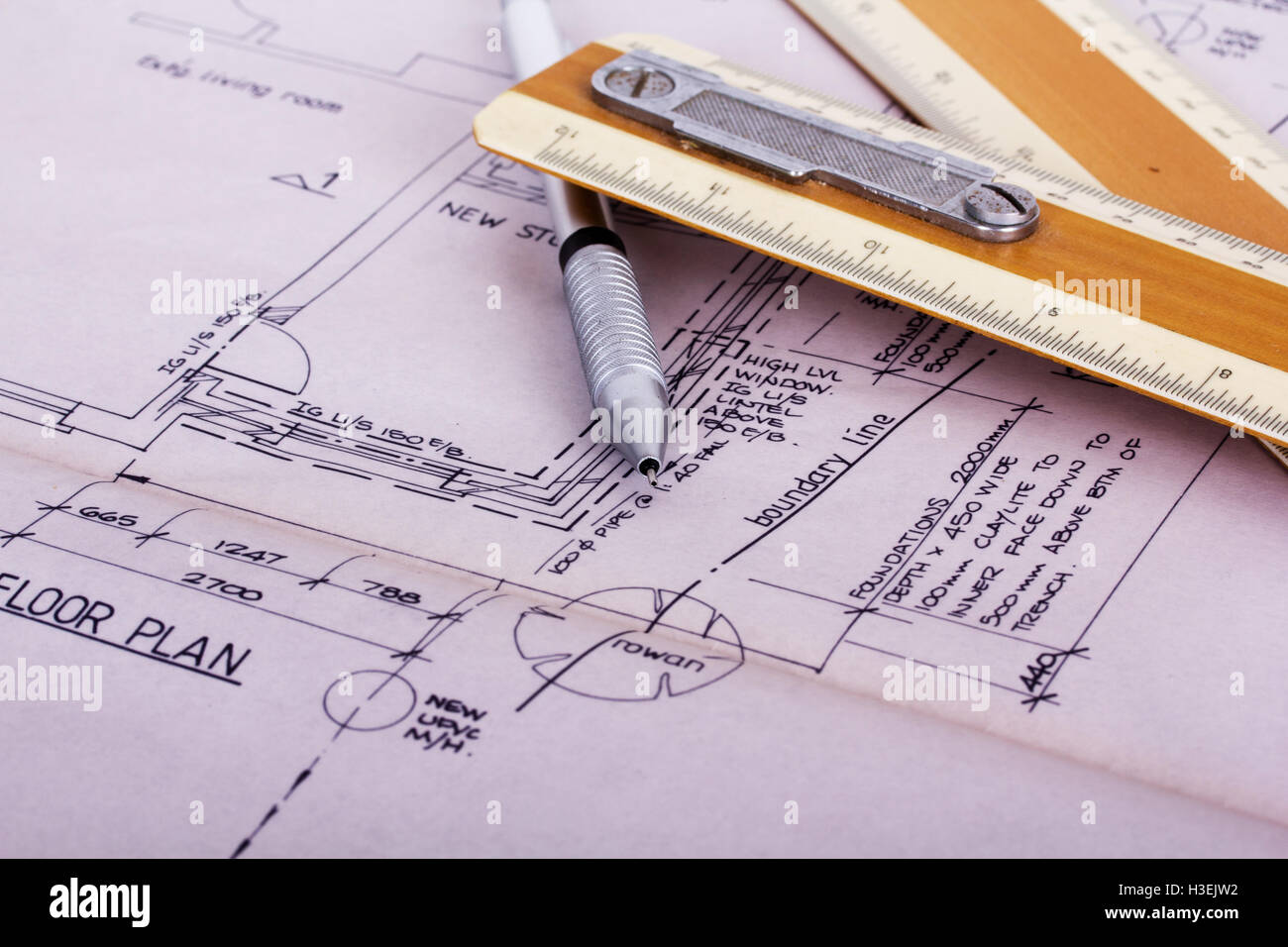 Drawing equipment on detailed architects house plans Stock Photo - Alamy