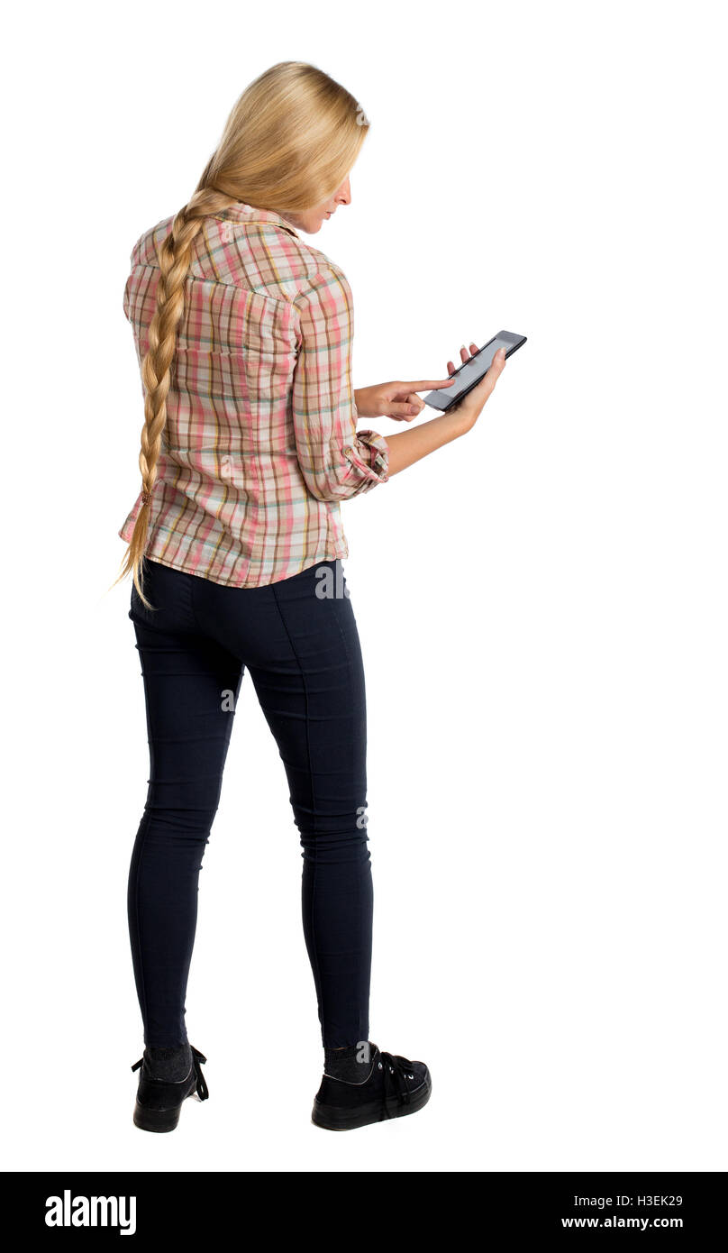 back view of standing young beautiful girl with tablet computer in the ...
