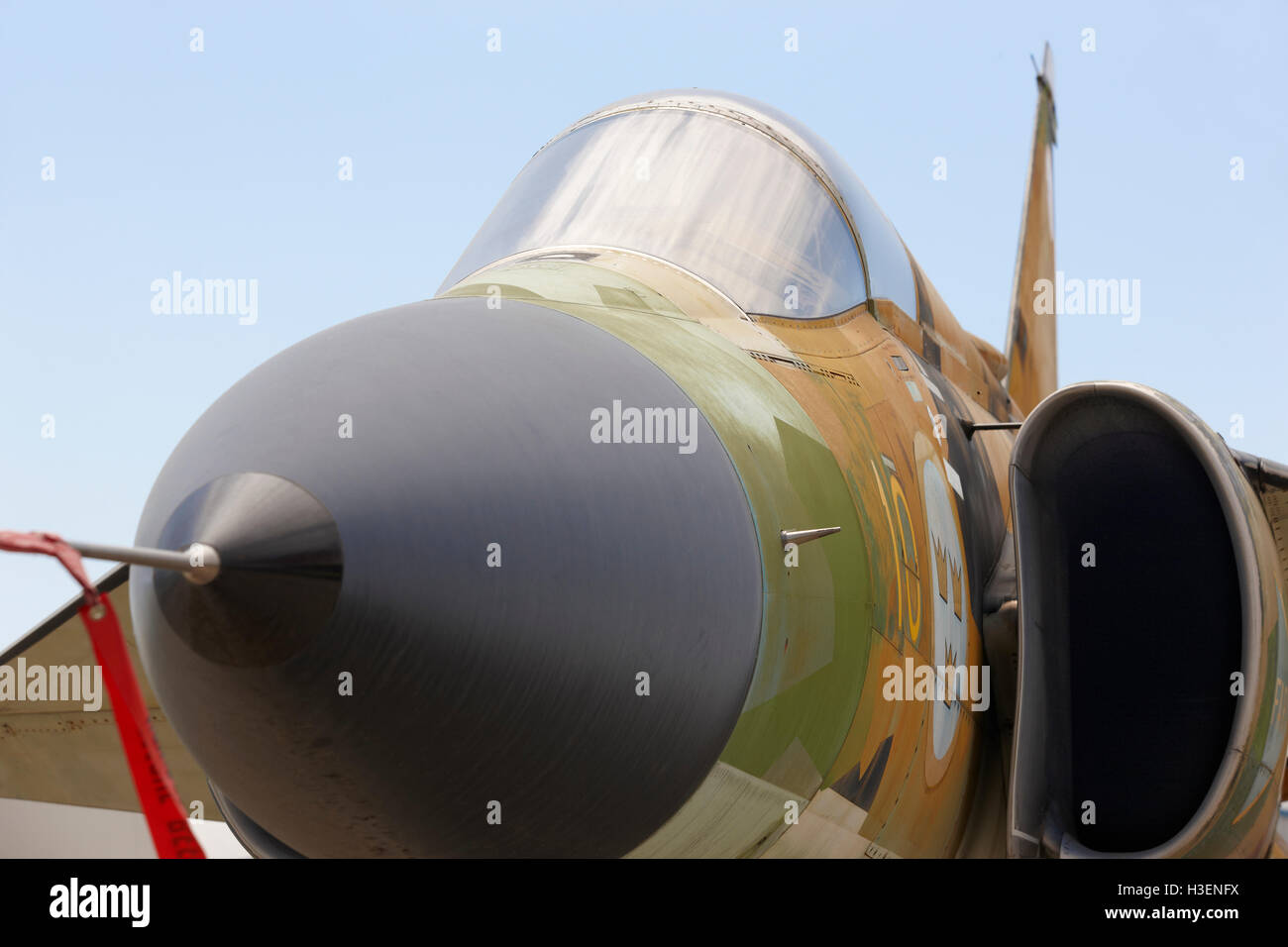 Fighter aircraft nose and cabin detail with blue sky background ...