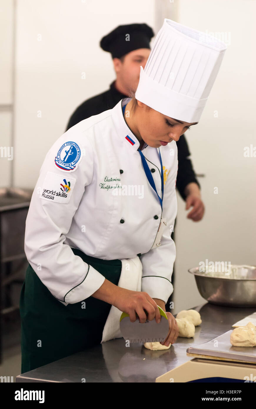 Girl-cook prepares food in competition Stock Photo - Alamy