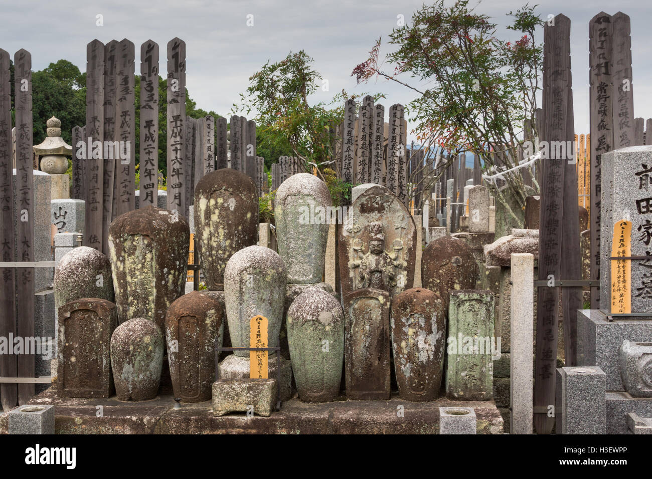 Old cylindrical tombstones set together on Japanese cemetery Stock ...