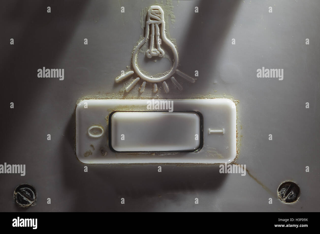Details of an old dirty plastic switch for turning light on or off ...