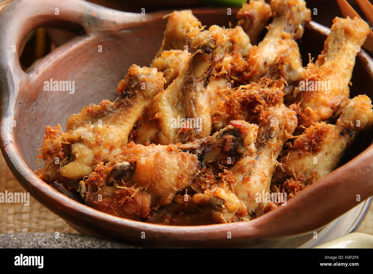 Fried chicken drummettes cooked with traditional Indonesian recipe ...