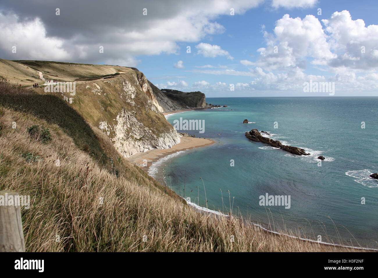 Looking out across "Man of war" bay with tide out and the cliffs and ...