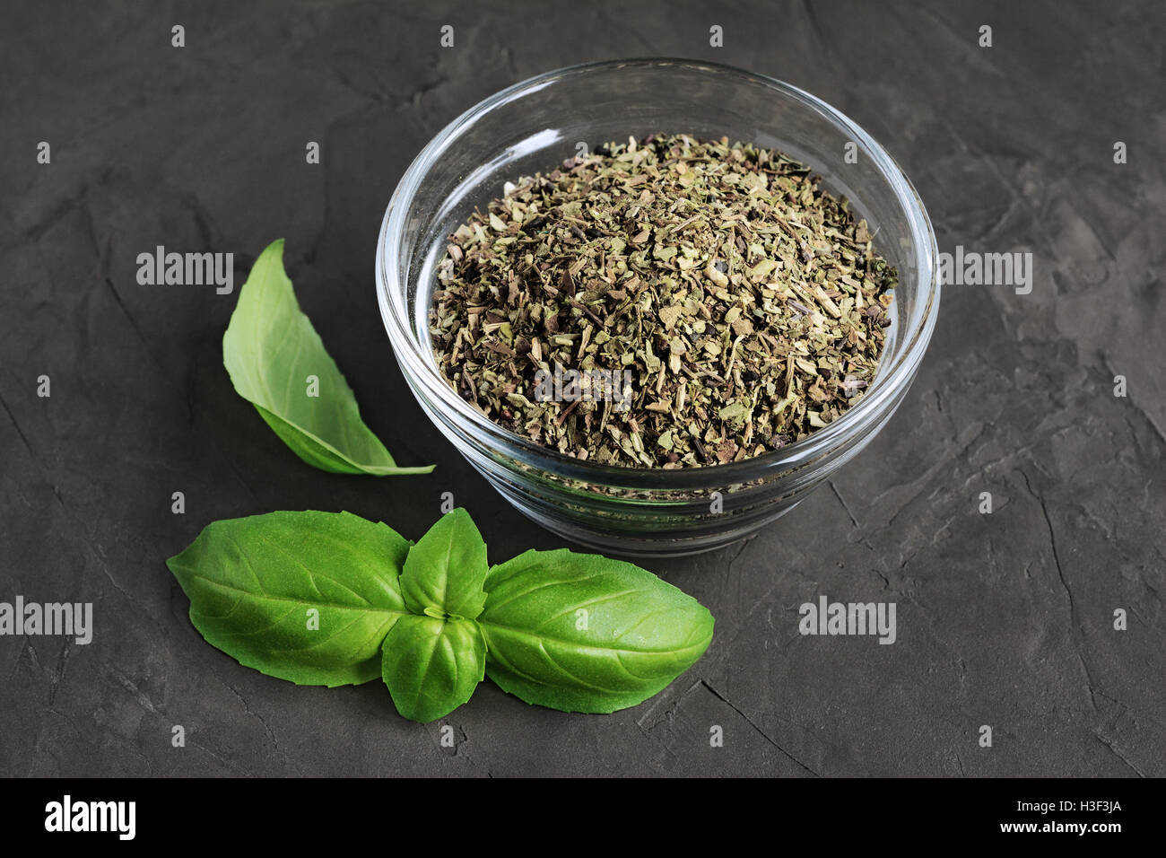 Dried and fresh basil on dark background Stock Photo - Alamy
