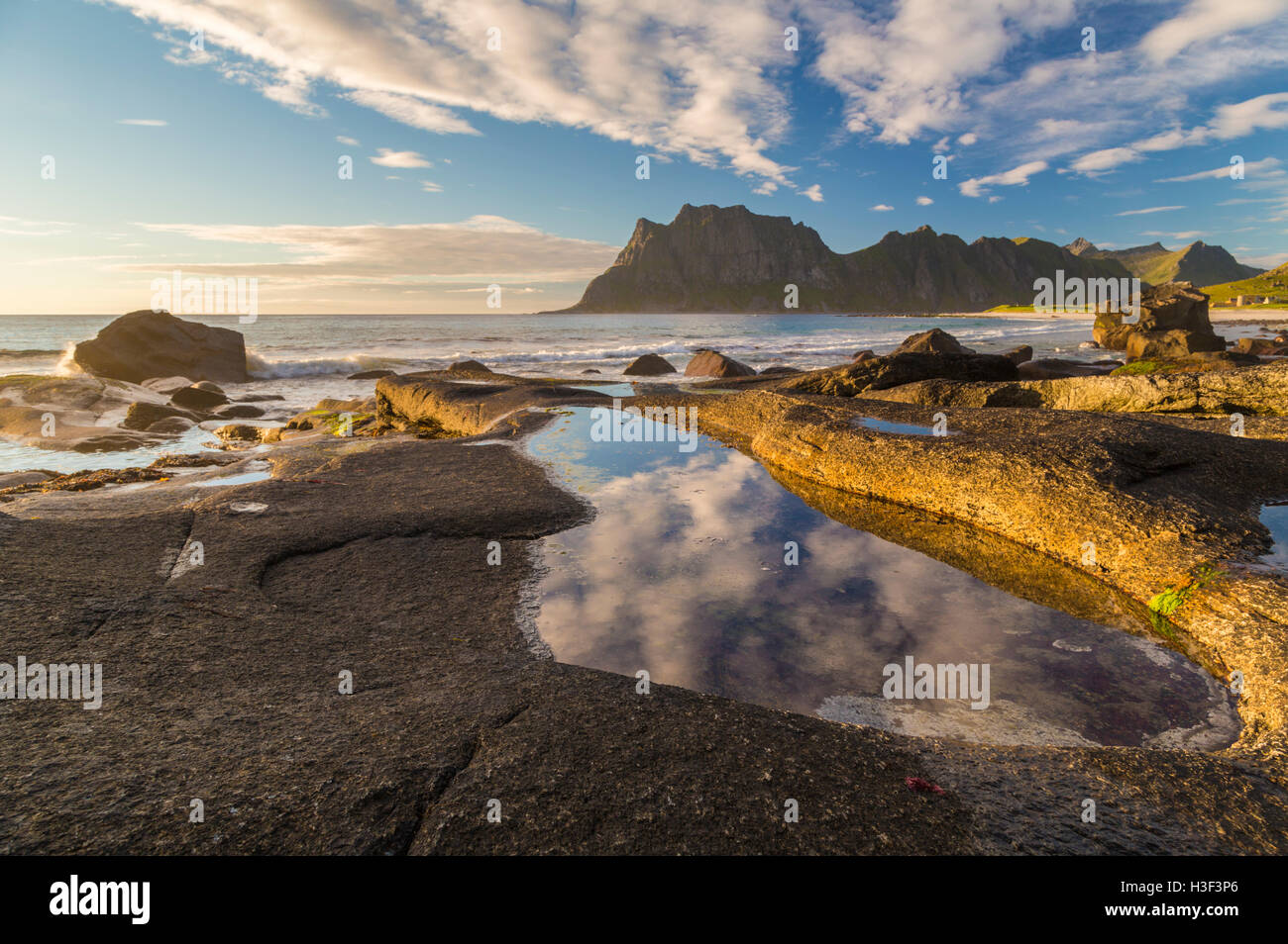 Rocks in evening light with warm light shining on them with sky ...