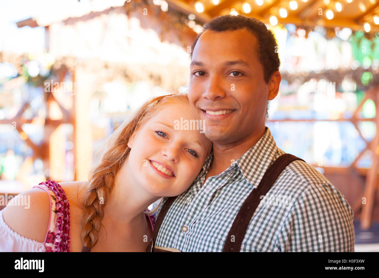 In love interracial couple enjoying Oktoberfest Stock Photo - Alamy