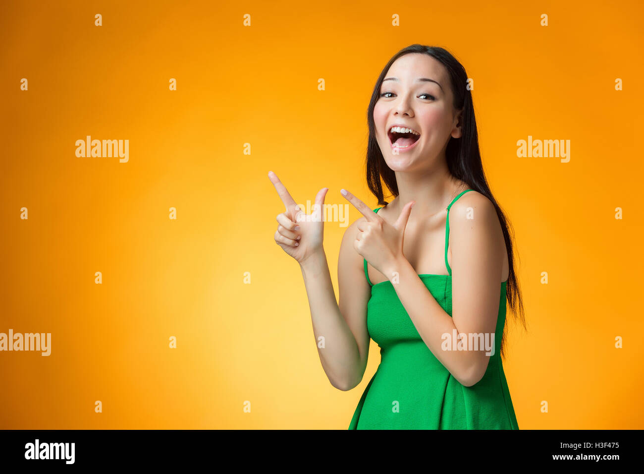 The happy Chinese girl on yellow background Stock Photo - Alamy