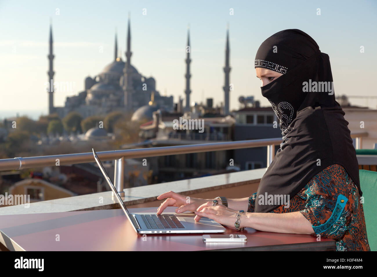 Traditionally dressed Muslim Woman working on computer Stock Photo - Alamy
