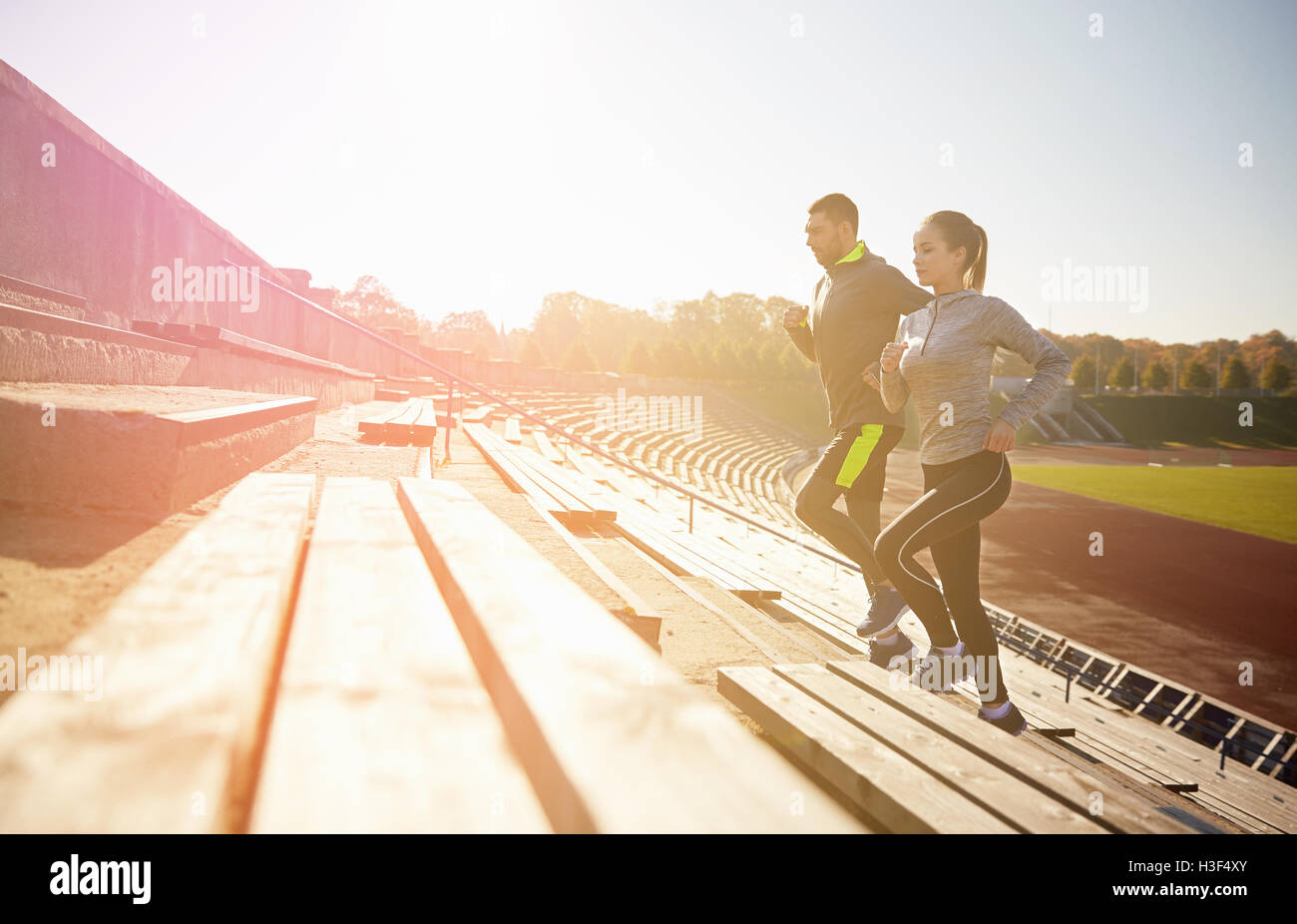 happy couple running upstairs on stadium Stock Photo - Alamy