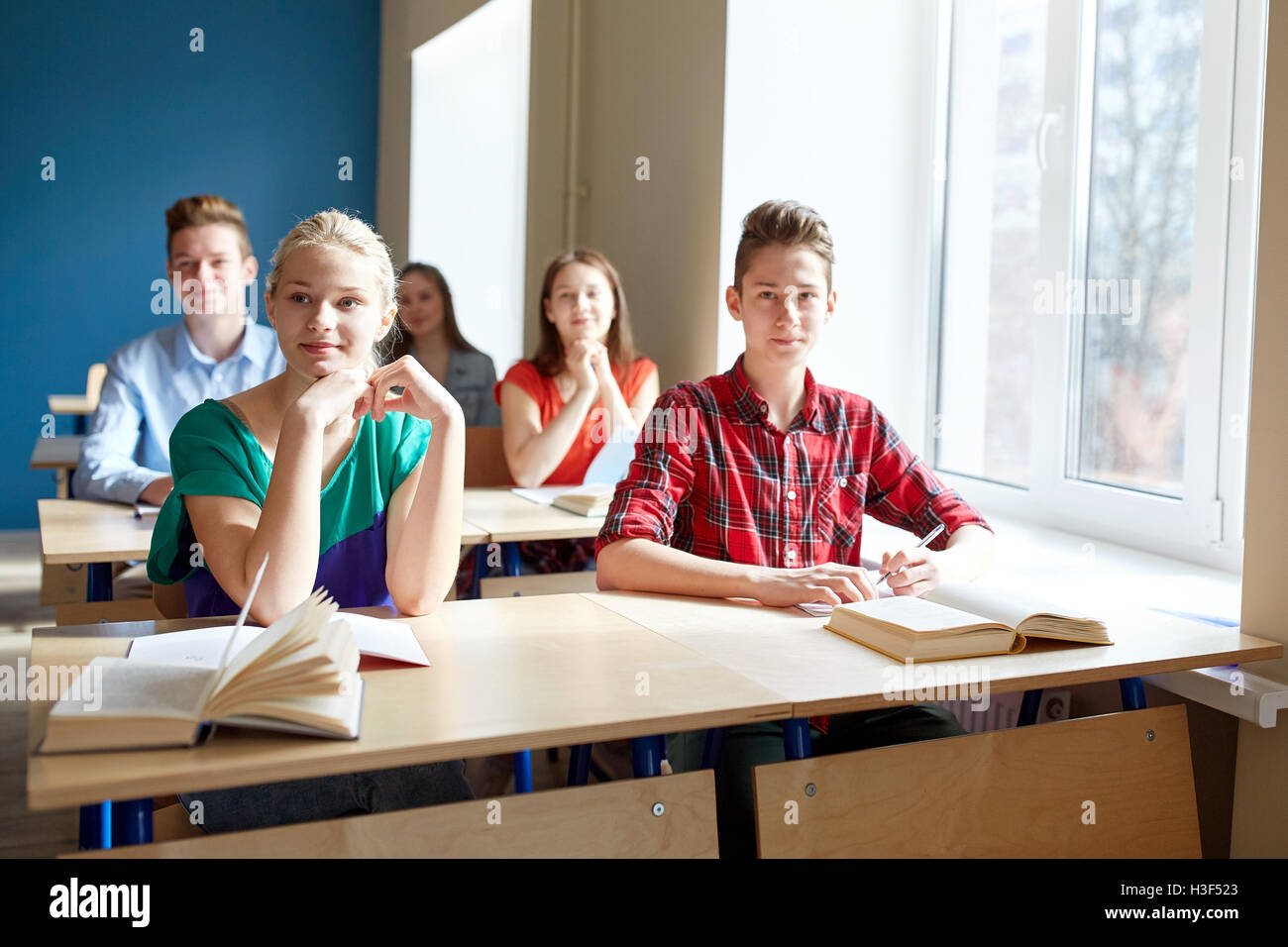 group of students with books at school lesson Stock Photo - Alamy