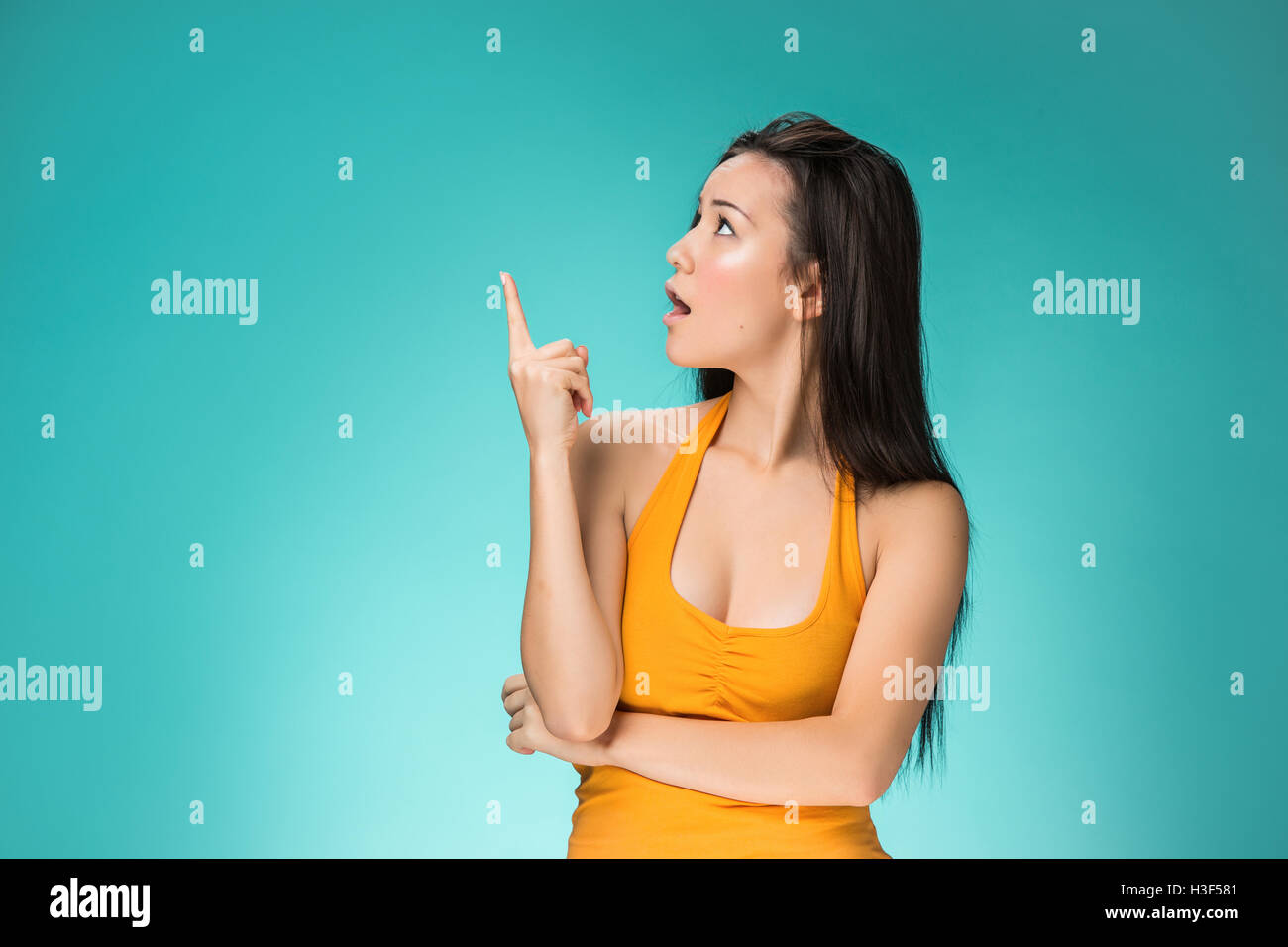 The happy Chinese girl on yellow background Stock Photo - Alamy