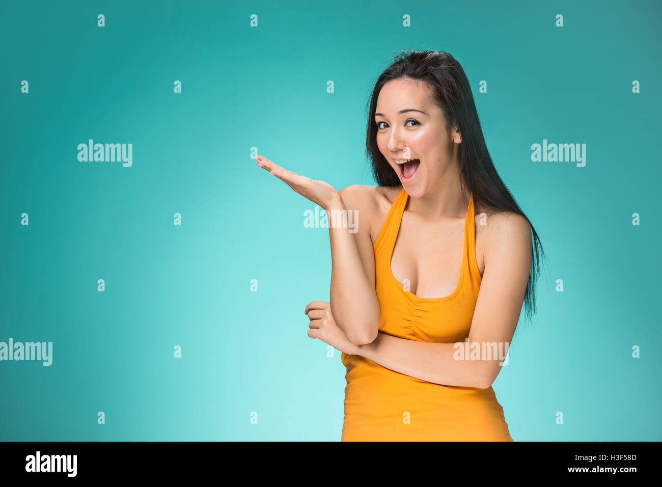 The happy Chinese girl on yellow background Stock Photo - Alamy