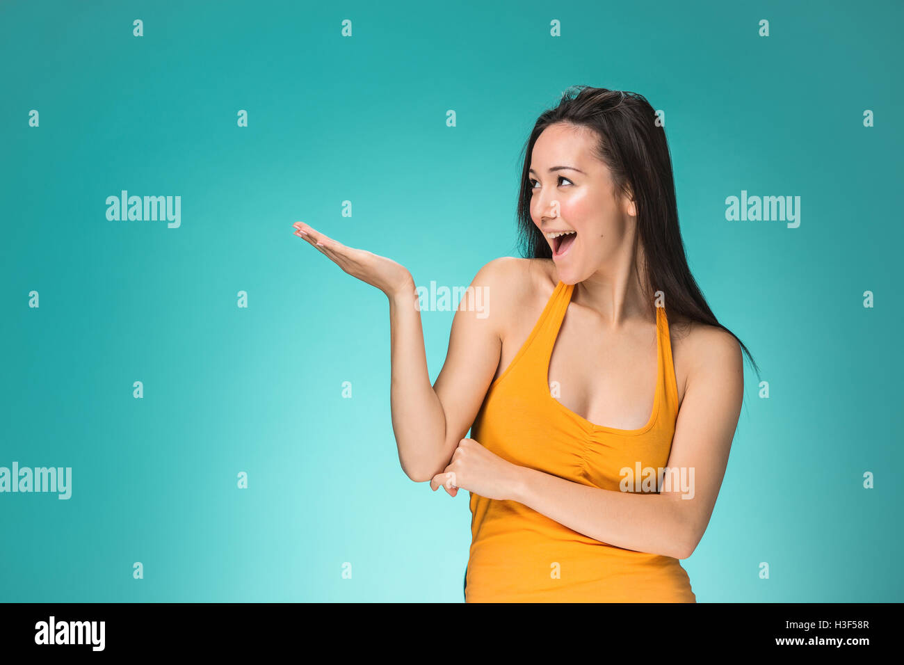 The happy Chinese girl on yellow background Stock Photo - Alamy