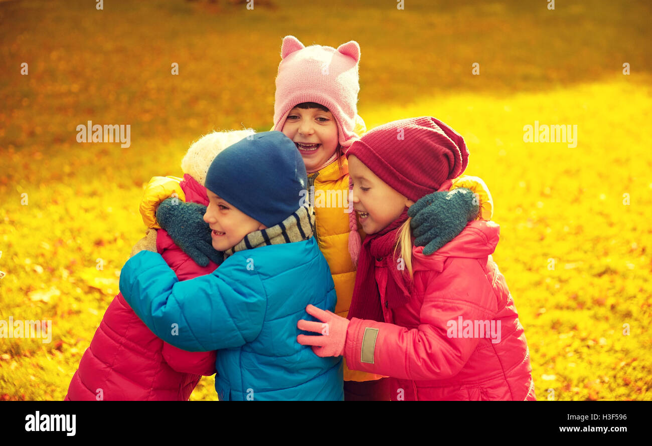 group of happy children hugging in autumn park Stock Photo - Alamy