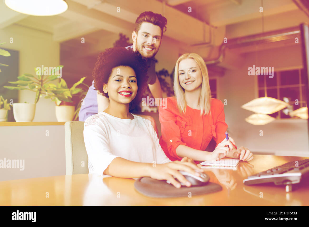 happy creative team in office Stock Photo - Alamy