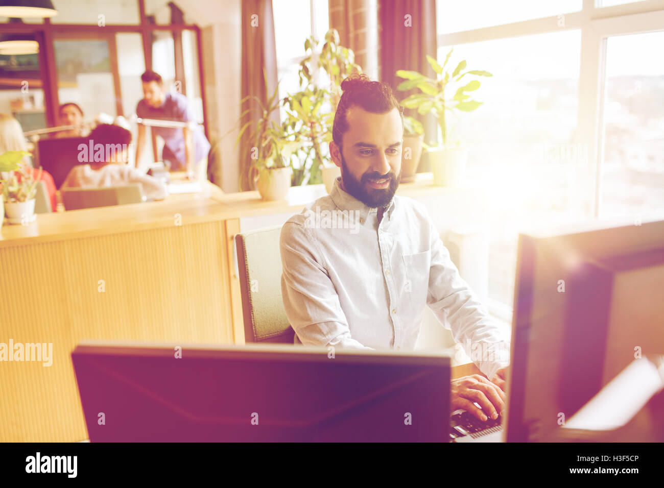 happy creative male office worker with computer Stock Photo - Alamy