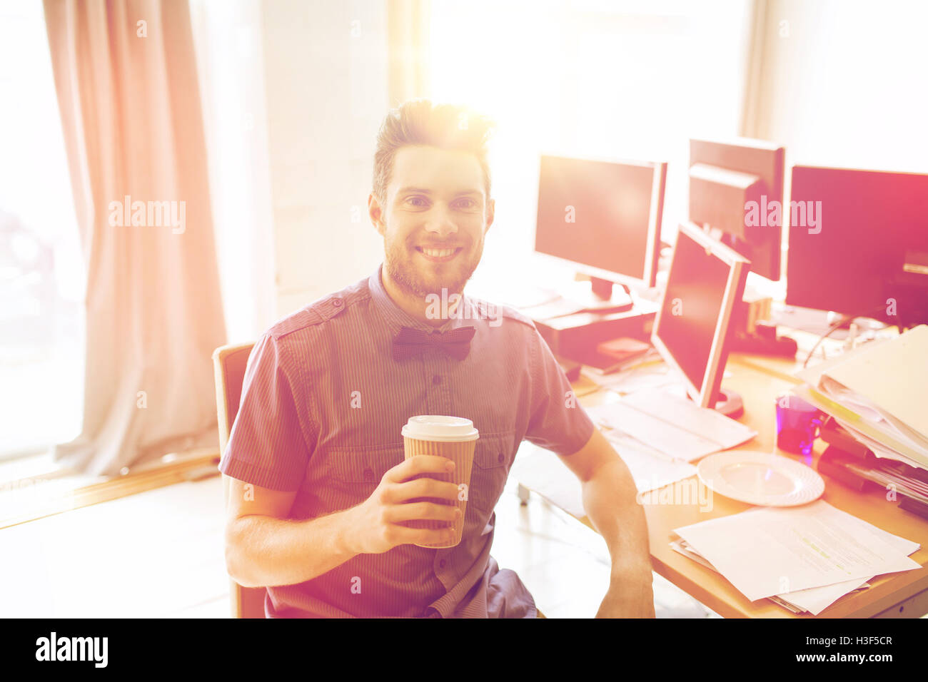 happy creative male office worker drinking coffee Stock Photo - Alamy