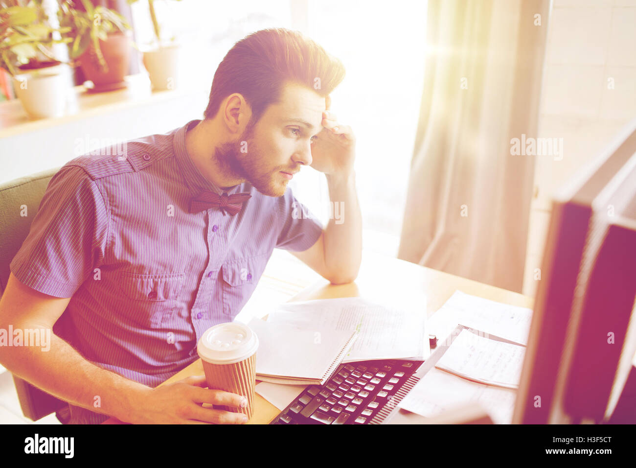 creative male worker with computer drinking coffee Stock Photo - Alamy