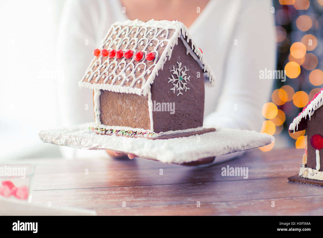 close up of woman showing gingerbread house Stock Photo - Alamy