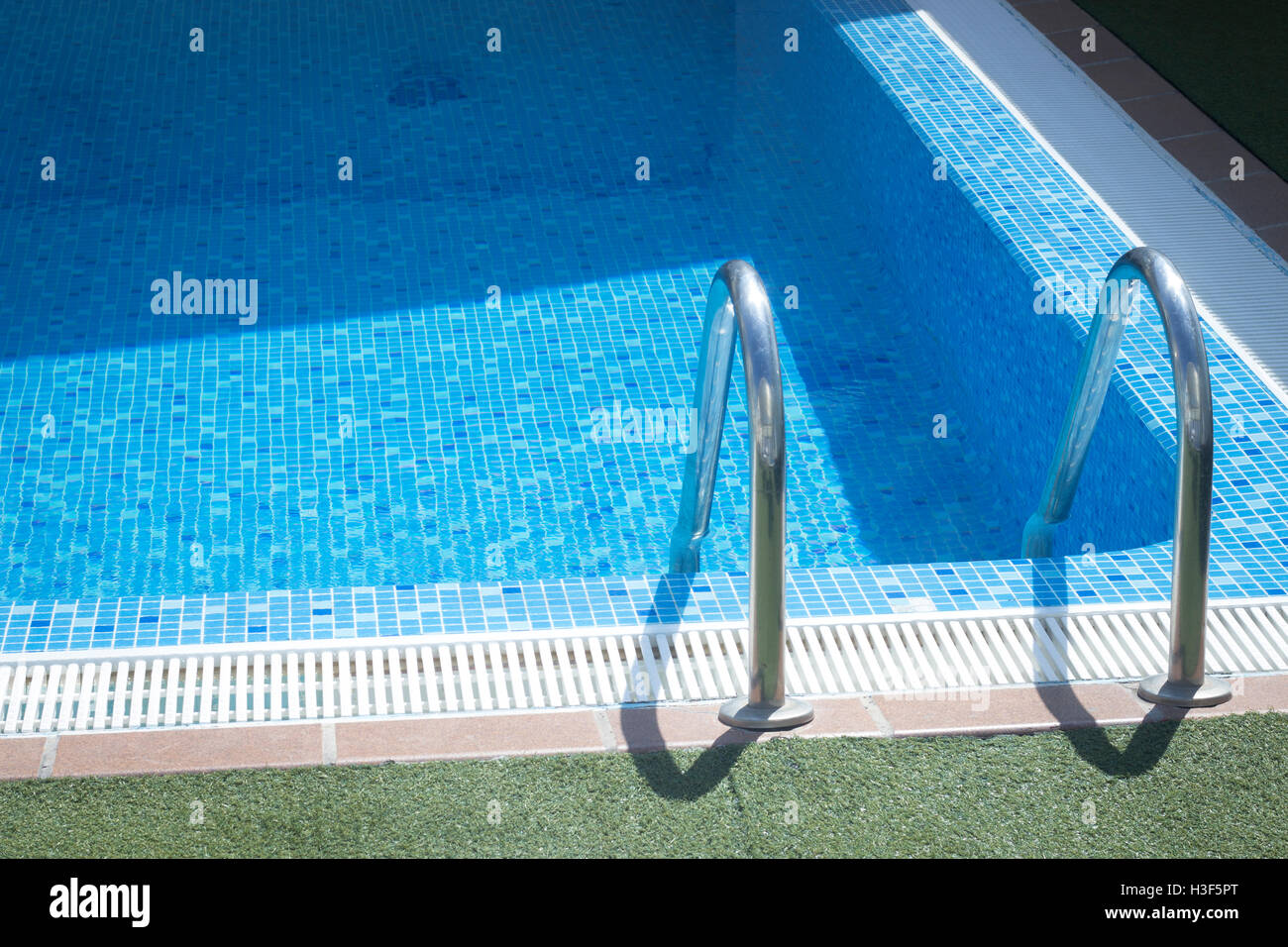 Outdoor swimming pool water on hot summer's day in luxury hotel resort ...