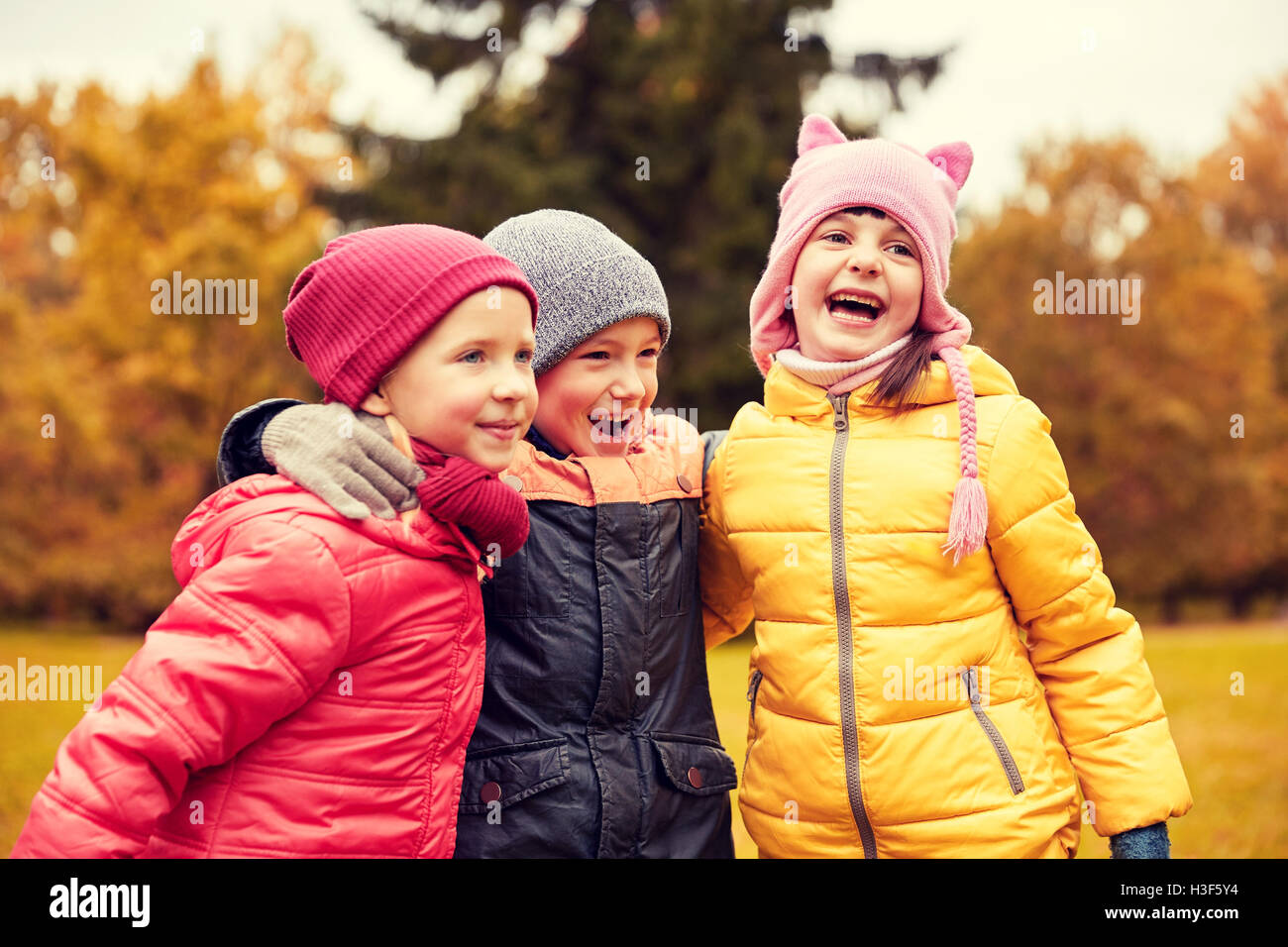 group of happy children hugging in autumn park Stock Photo - Alamy