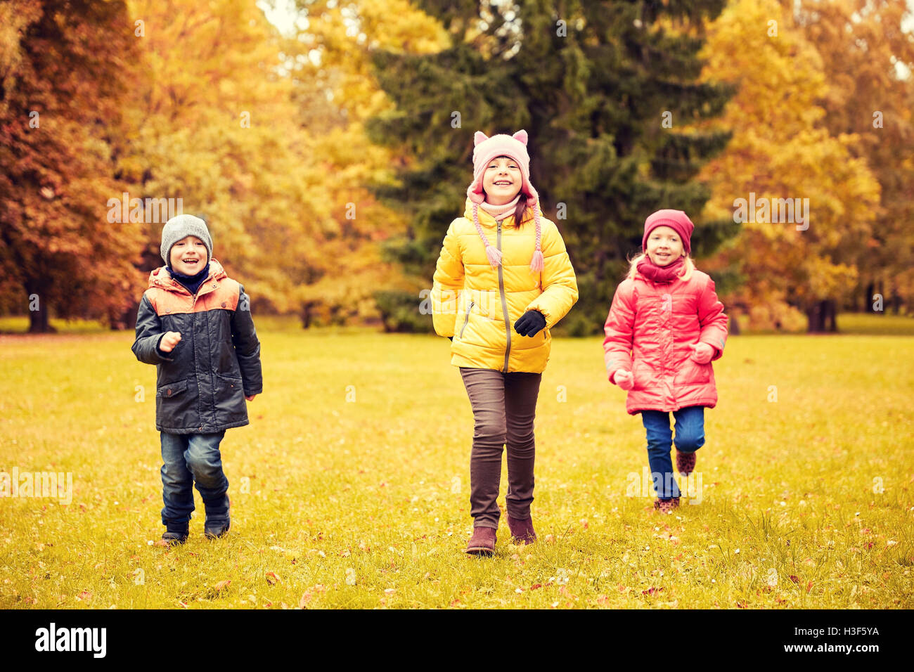 group of happy little kids running outdoors Stock Photo - Alamy