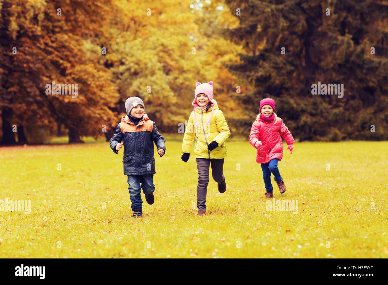 group of happy little kids running outdoors Stock Photo - Alamy