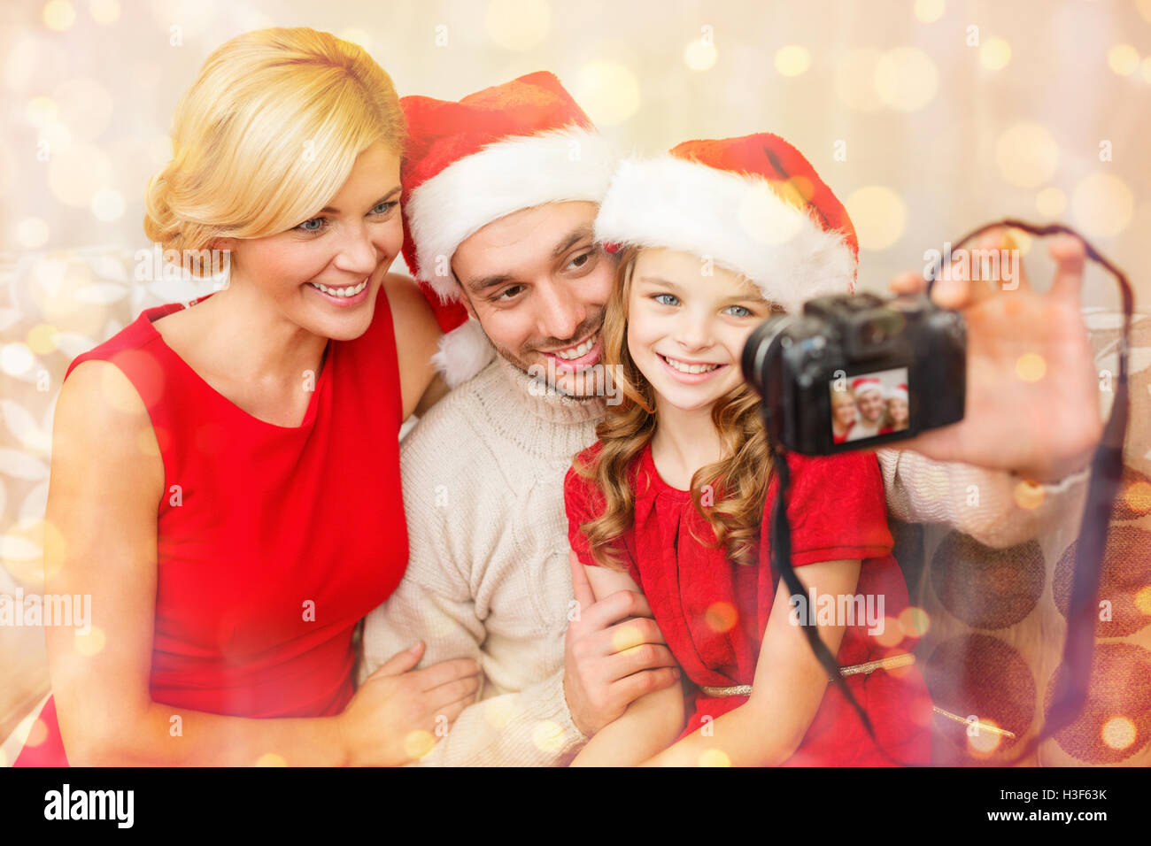 smiling family in santa helper hats taking picture Stock Photo - Alamy