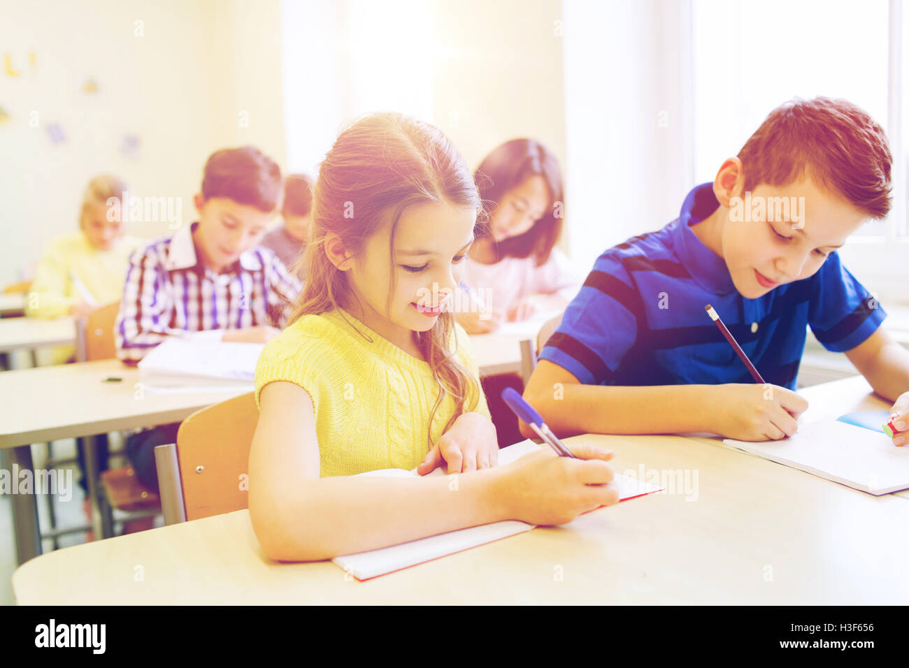 group of school kids writing test in classroom Stock Photo - Alamy