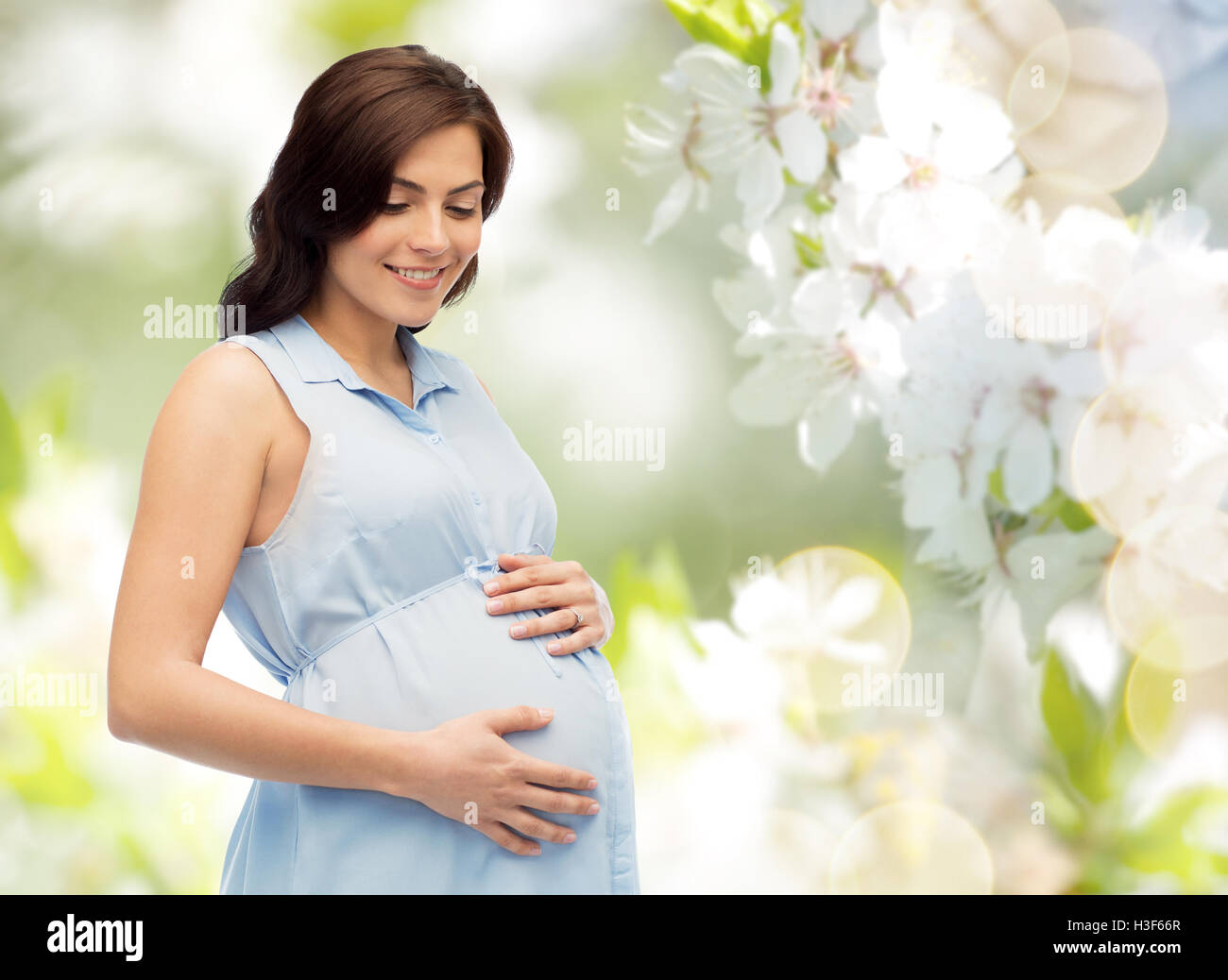 happy pregnant woman touching her big belly Stock Photo - Alamy