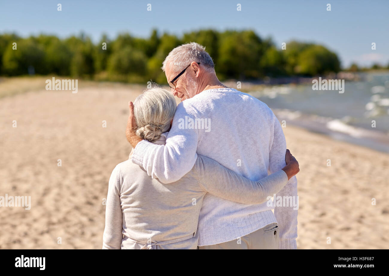 happy senior couple hugging on summer beach Stock Photo - Alamy