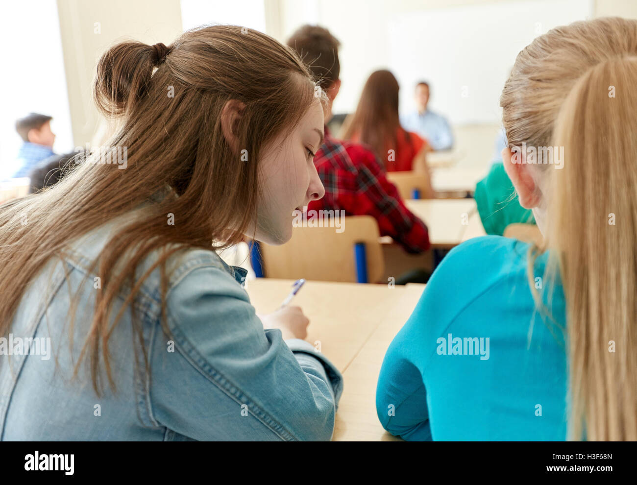 group of students writing school test Stock Photo - Alamy
