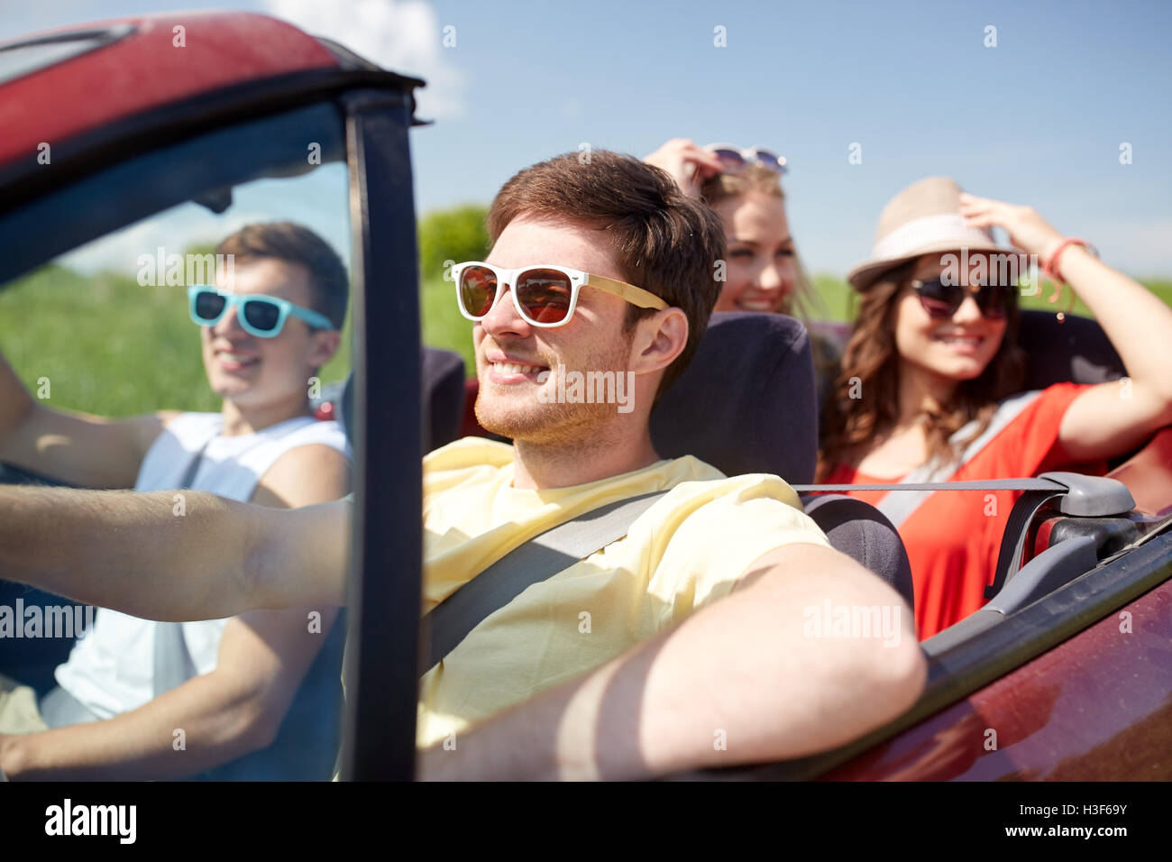 happy friends driving in cabriolet car Stock Photo - Alamy